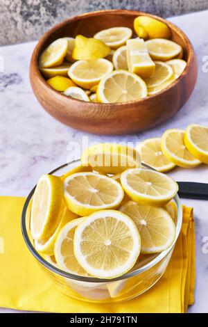 Bowls of slices of lemon on a marble surface Stock Photo - Alamy
