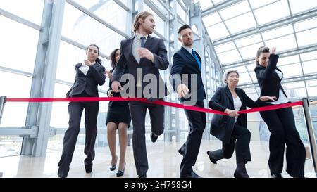 Businesspeople crossing the finish line rat race business people ...