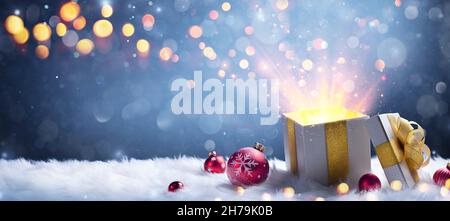 Open gift box with blue ribbon and bow blue background Stock Photo - Alamy