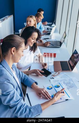 employees discuss work issues Stock Photo - Alamy