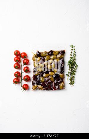 Greece olives in plastic pack, on black dark stone table background ...