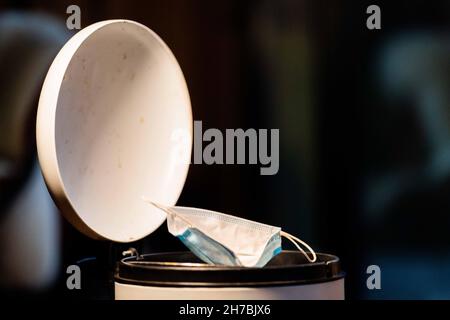 Dropping and throwing a covid 19 delta mask in a bin and the trash in ...