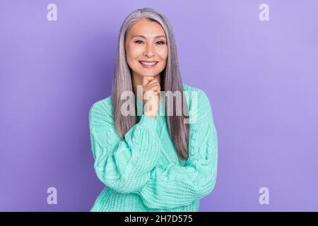 Photo of pretty minded girl hand touch chin look empty space hold ...