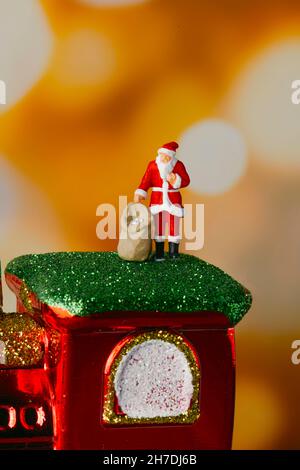 Toy Christmas train carrying gifts, a reindeer, and a fir tree on a ...