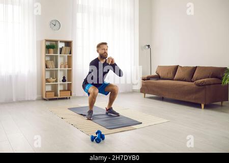 Guy doing some training at home to keep in good shape Stock Photo - Alamy
