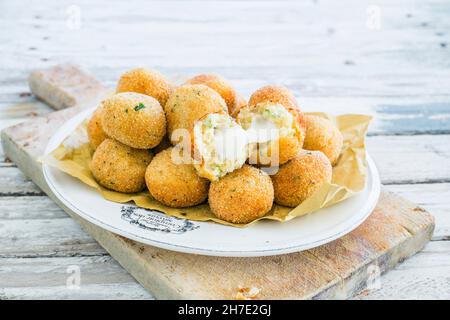 Fried potato balls with cheese centres Stock Photo - Alamy