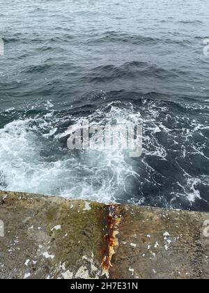 Vertical shot of sea waves splashing on the beach Stock Photo - Alamy