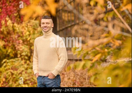 A man in na beige turtleneck in th autumn park Stock Photo - Alamy