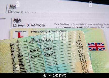UK Provisional Driving Licence cards placed on top of the genuine ...