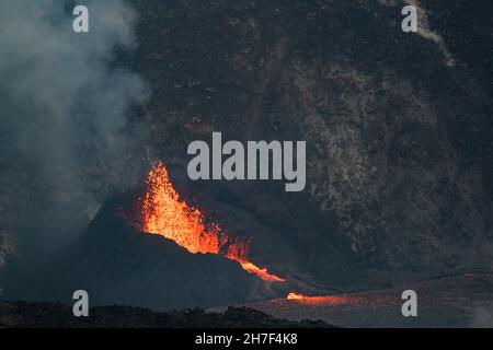 hot lava fountaining from a vent within a spatter cone feeds a growing ...