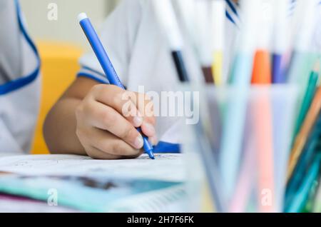 Hands with colored pencils drawing on paper. Salvador, Bahia, Brazil ...