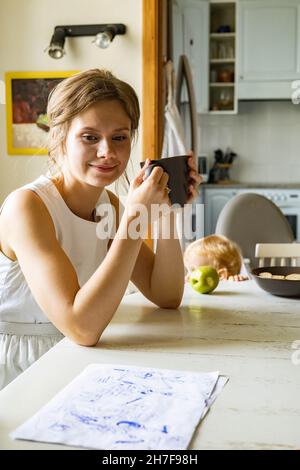 happy teen girl making notes in notebook sitting on grass. taking notes ...