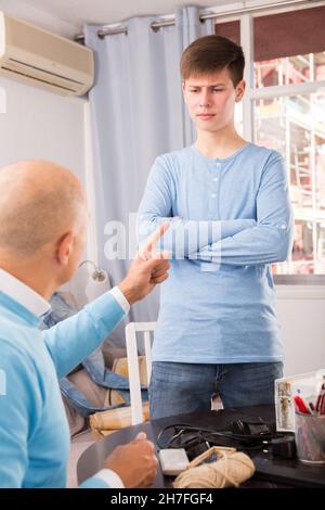 Serious father lecturing his son Stock Photo - Alamy