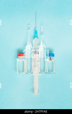 Medical bottles and syringe on light gray tone Stock Photo - Alamy