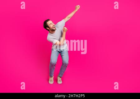 Full length photo of crazy lucky person raise fists triumph jumping ...