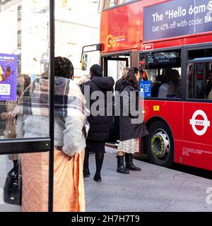 Bus stop passengers queuing to board bus in St Peters Square, Hereford ...