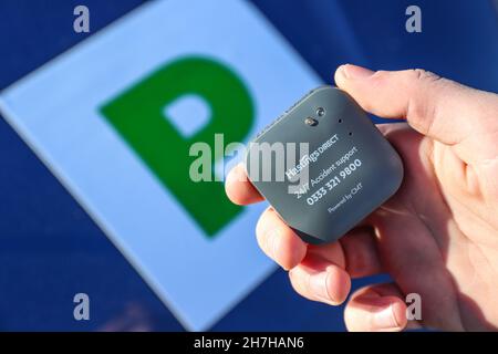 A young driver about to install a UK car insurance telematics black box ...