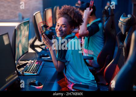 Cute woman gamer getting ready for game in computer club Stock Photo ...