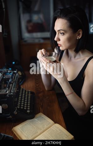 Female artist drinking coffee in workshop Stock Photo - Alamy