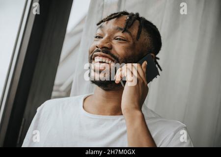 Low angle of young bearded African American male in black sweatshirt ...