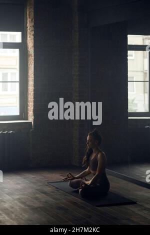 Young sportswoman in lotus position Stock Photo - Alamy