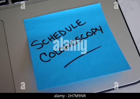 Sticky note reminder to schedule colonoscopy, a screening for ...