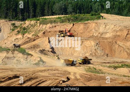 Excavator developing the sand on the opencast and loading it to the ...