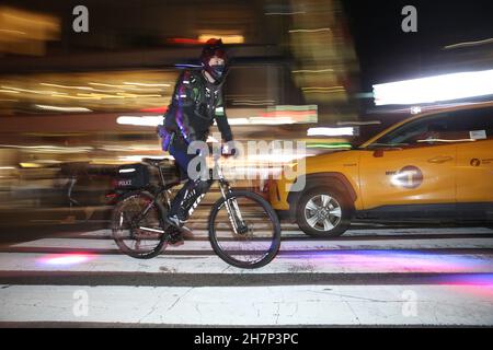 An NYPD officer wearing a riot gear helmet stands by in Times Square as ...