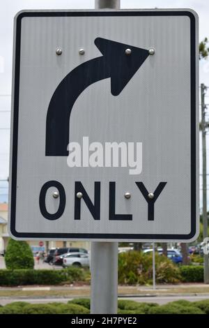 A stop sign and right turn only arrow sign Stock Photo - Alamy