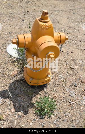 Freshly painted yellow fire hydrant surprisingly in an unmade road, it ...