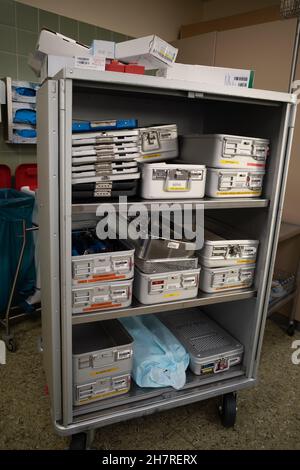 in a sterilization department instrument containers are stacked next to ...