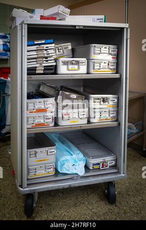 in a sterilization department instrument containers are stacked next to ...