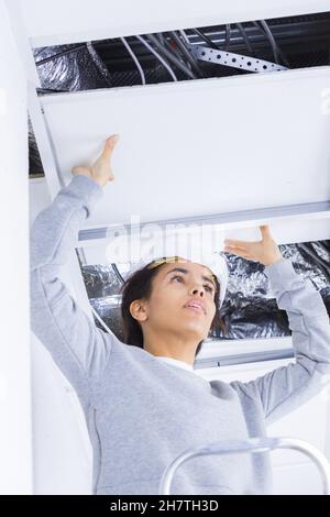 Builder replacing ceiling panel, working, ceiling armstrong Stock Photo ...