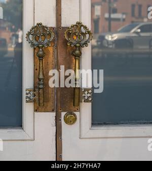 Closeup of old door handles and a keyhole with antique decorations ...