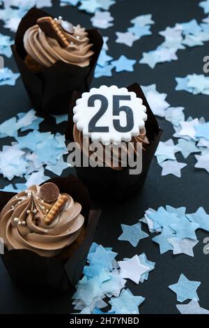 Number 25 on Delicious chocolate cupcake with cream on dark background ...