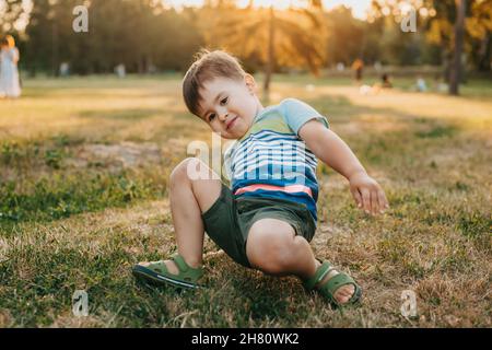 Little boy running down a path lined with grass Stock Photo - Alamy