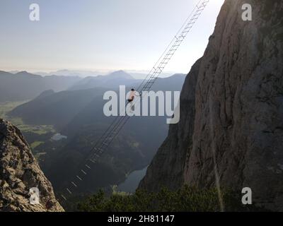 Intersport Donnerkogel via ferrata in Summer, with a man showing a ...