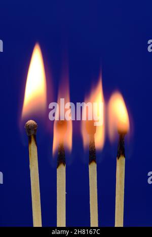 Multi-colored matches on a black background with arrows symbolizing the ...