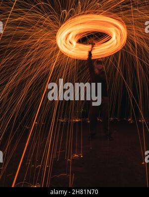 Steel wool photography light painting at night Stock Photo - Alamy