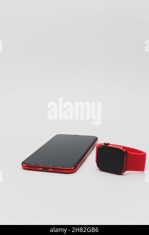 INVERIGO, ITALY - Nov 25, 2021: Apple watch product red and iphone on a ...
