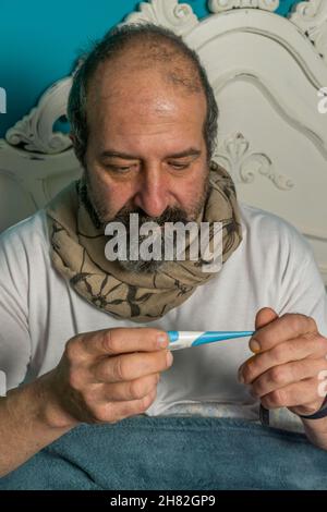 sick man in bed with fever Stock Photo - Alamy