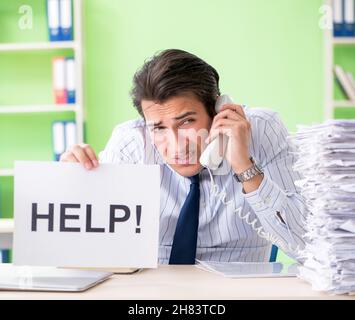 Businessman having problems with paperwork and workload Stock Photo - Alamy