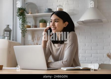 Happy asian woman sit on wooden balcony touching cute domestic cat with ...