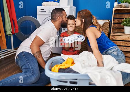 Family kissing son washing clothes at laundry room Stock Photo - Alamy