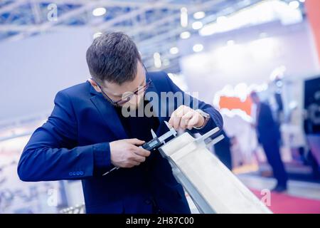 Engineer checks dimensions with vernier caliper control quality of ...