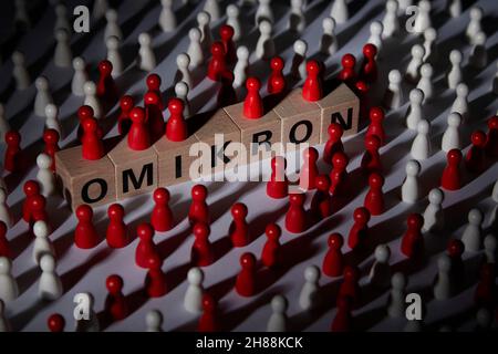 wooden blocks with the word delta and red figurines building a symbol ...
