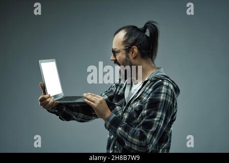 Man gawping at his laptop with an aghast expression Stock Photo - Alamy