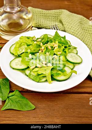 Salad from spinach and cucumbers with napkin on table Stock Photo - Alamy