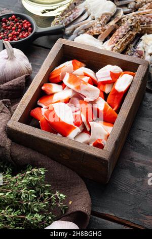Asian snack surimi set, in wooden box, on dark wooden background, top ...