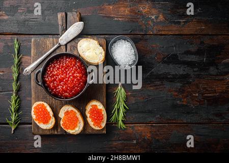 Sandwiche with red fish caviar, on old dark wooden table background ...
